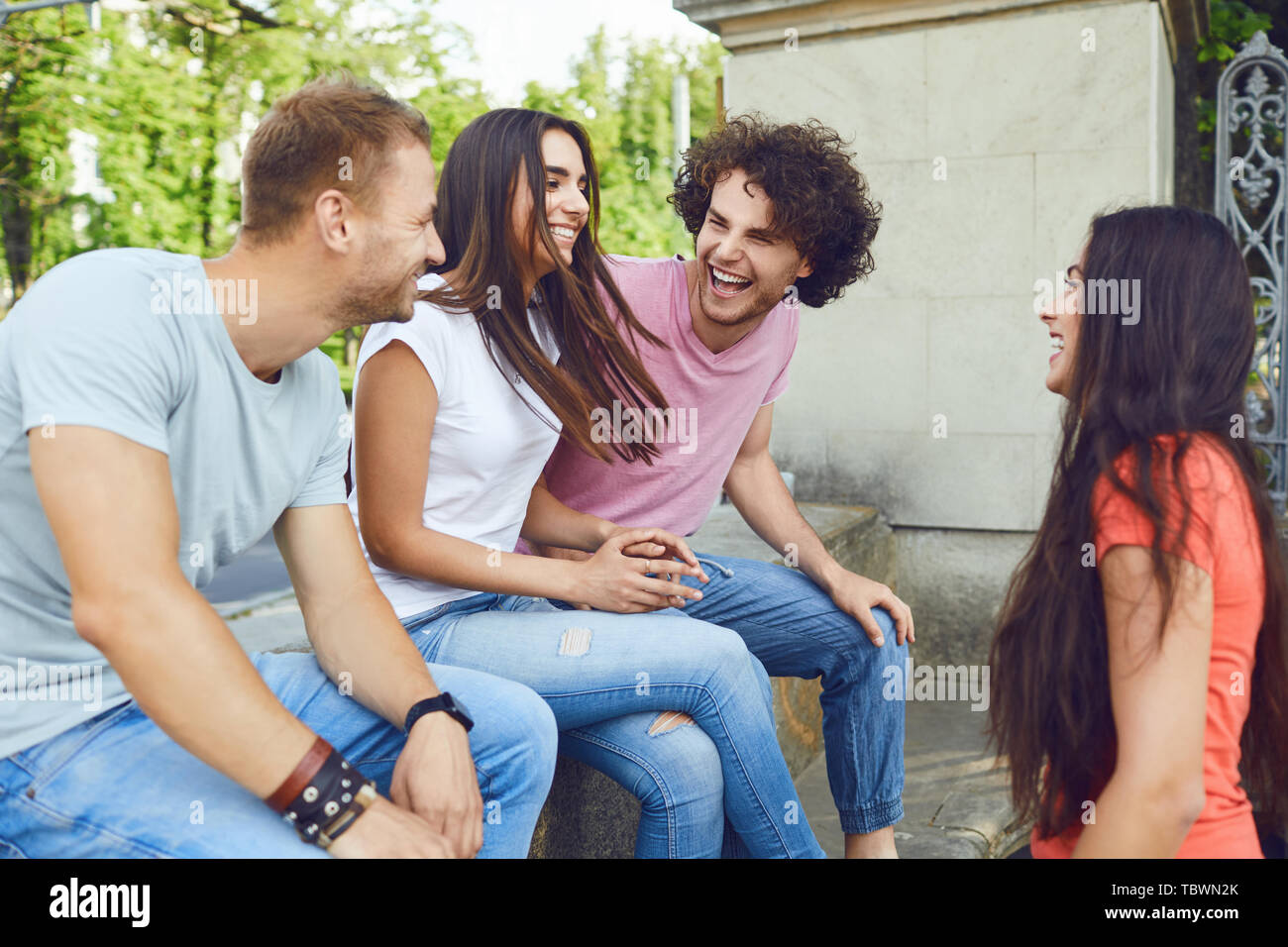 Friends laughing sitting in nature hi-res stock photography and images ...