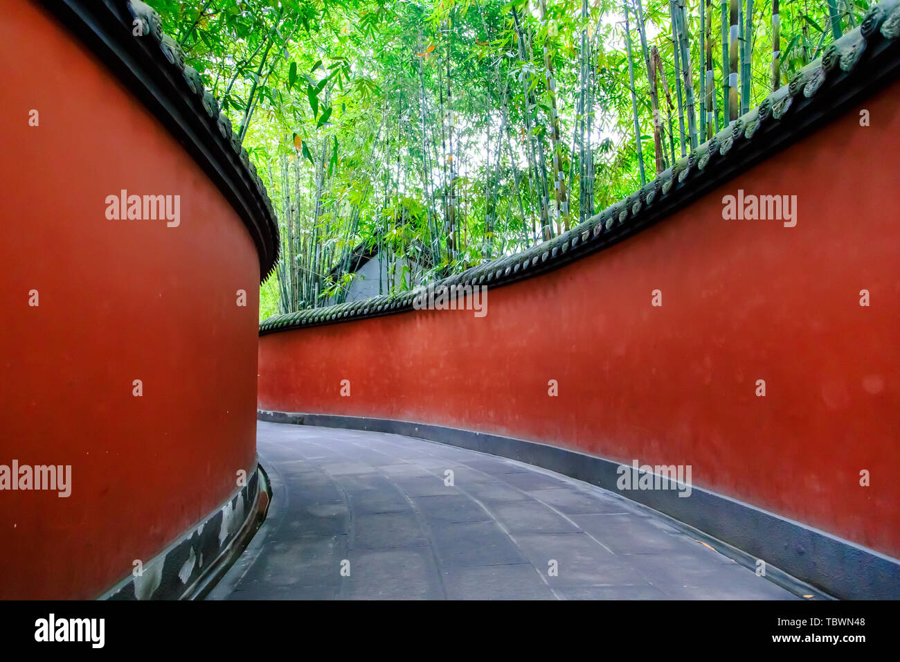 Red palace wall, winding passageway, with emerald bamboo forest Stock ...