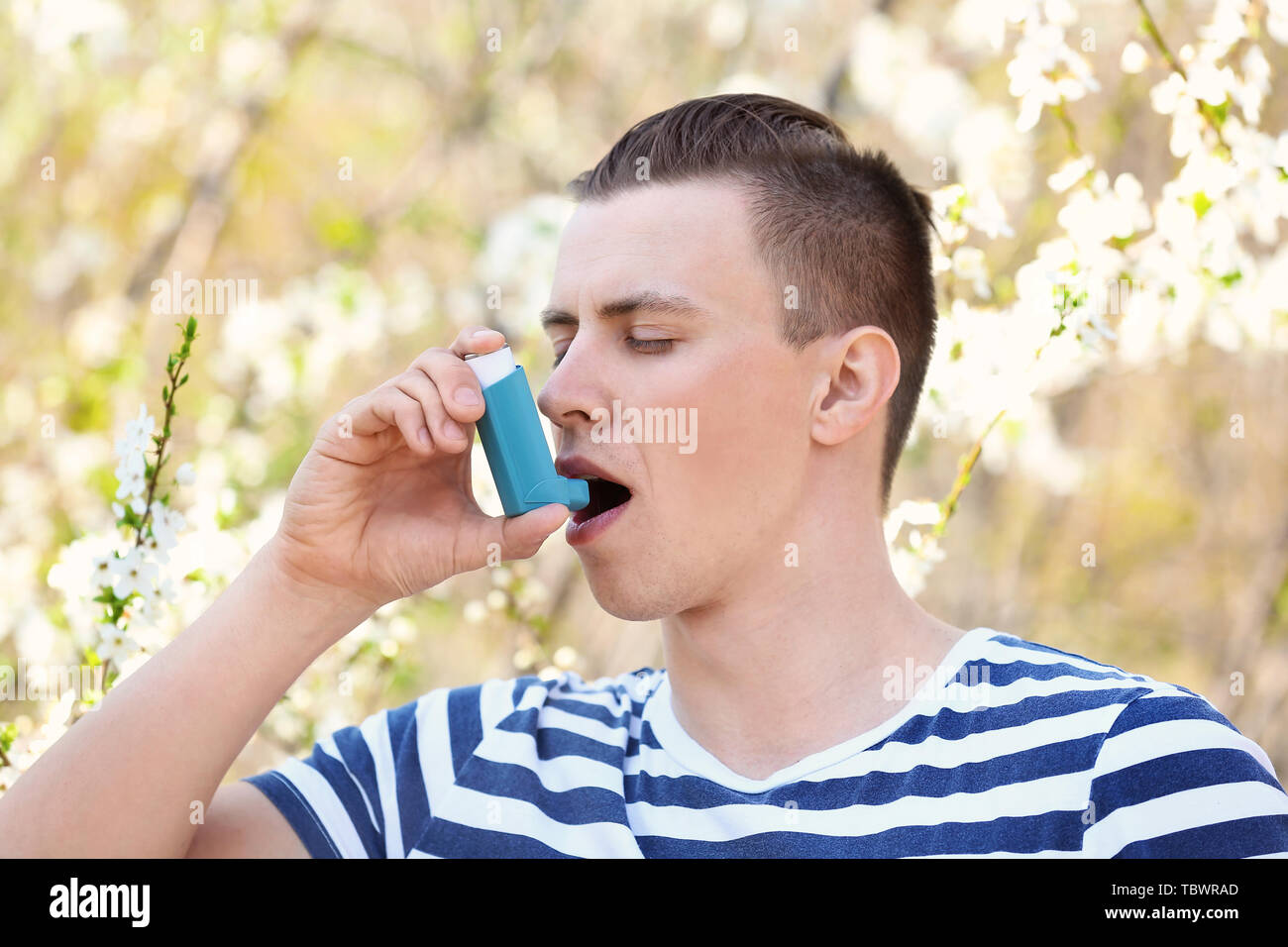 Man with inhaler having asthma attack on spring day Stock Photo - Alamy