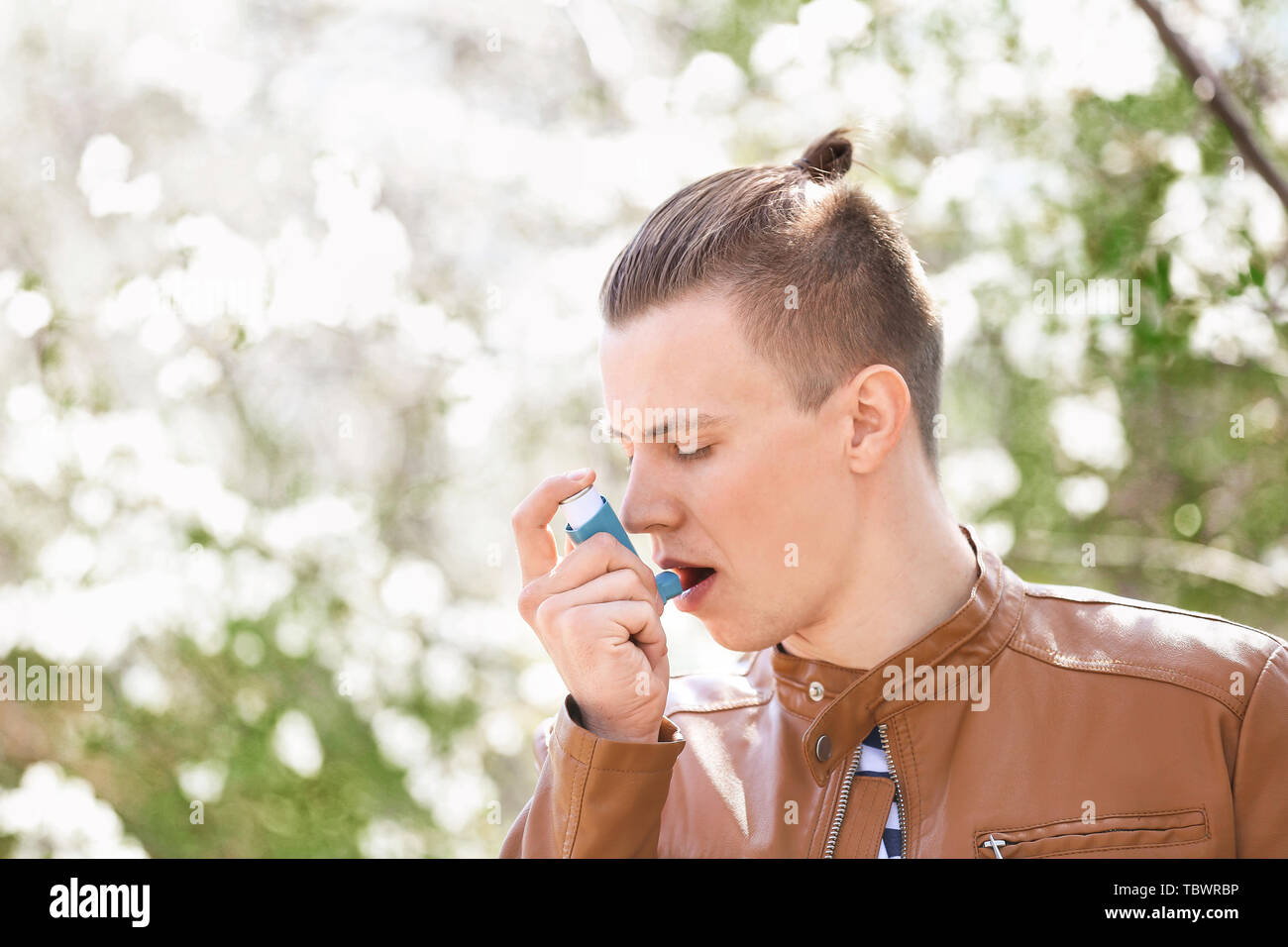 Man with inhaler having asthma attack on spring day Stock Photo - Alamy