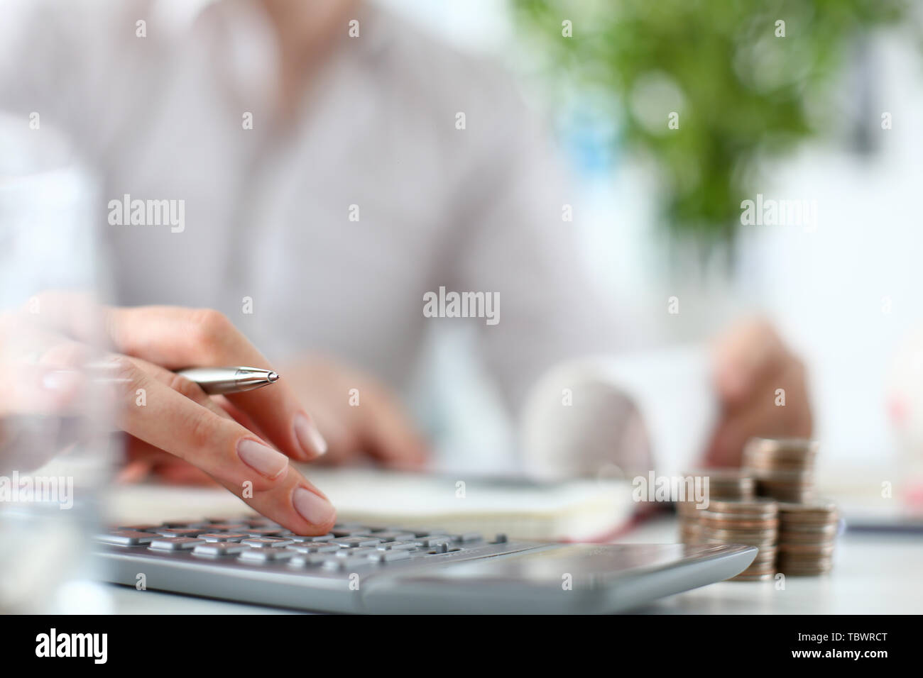 Woman hand push on calculator keyboard Stock Photo - Alamy