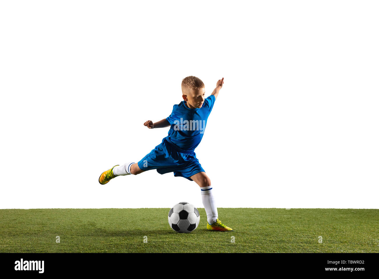 Young boy as a soccer or football player in sportwear making a feint or ...