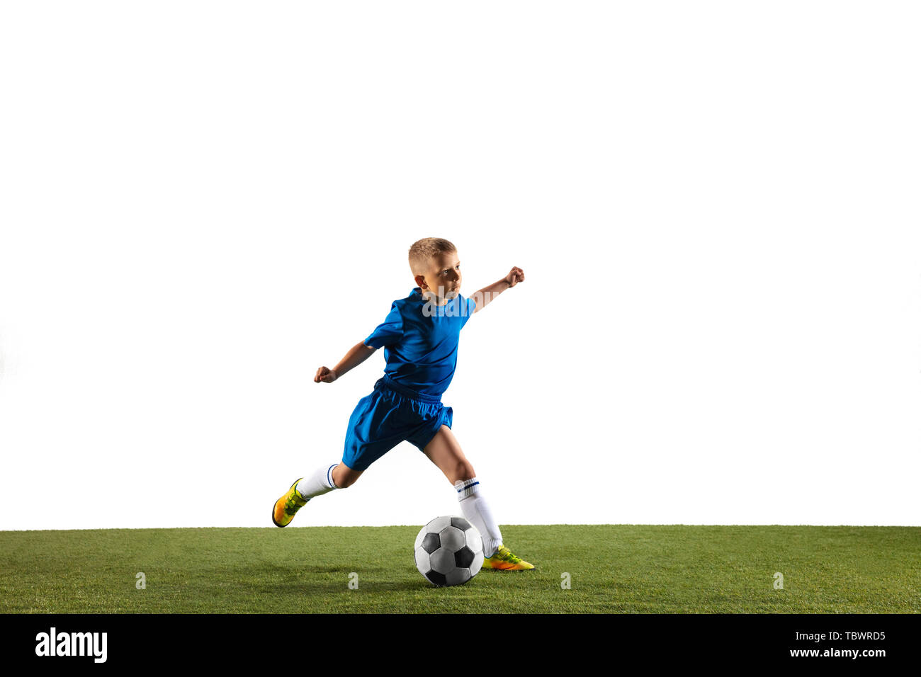 Young boy as a soccer or football player in sportwear making a feint or ...