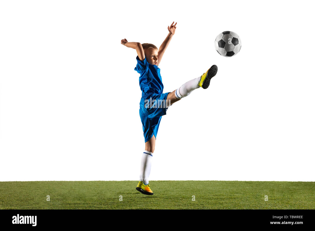 Young boy as a soccer or football player in sportwear making a feint or ...
