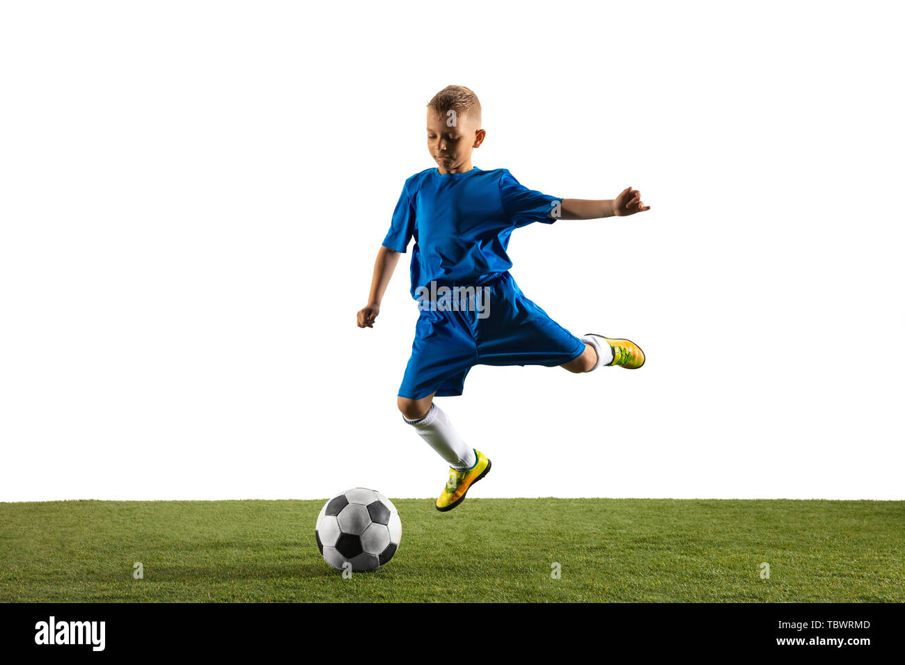 Young boy as a soccer or football player in sportwear making a feint or ...