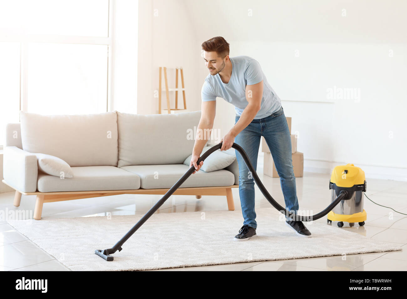 Man hoovering room hi-res stock photography and images - Alamy
