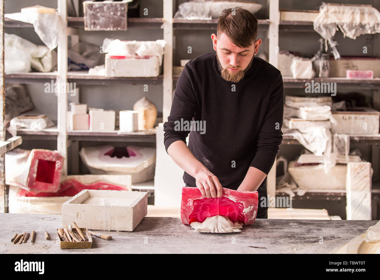The sculptor works in the Studio. Creation of a decorative element from ...