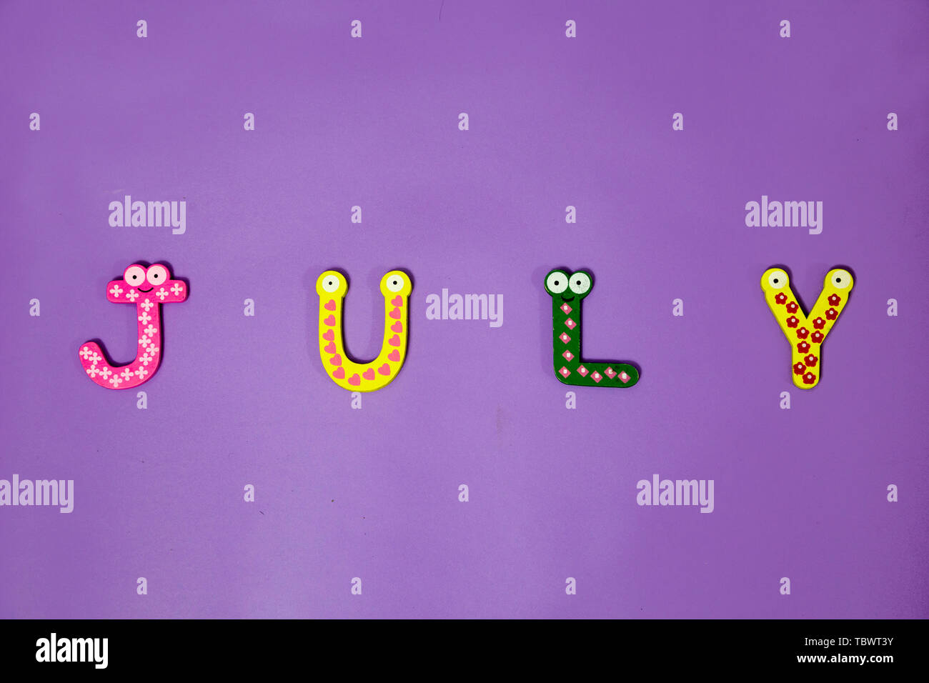 Color english puzzle word building blocks july Stock Photo - Alamy