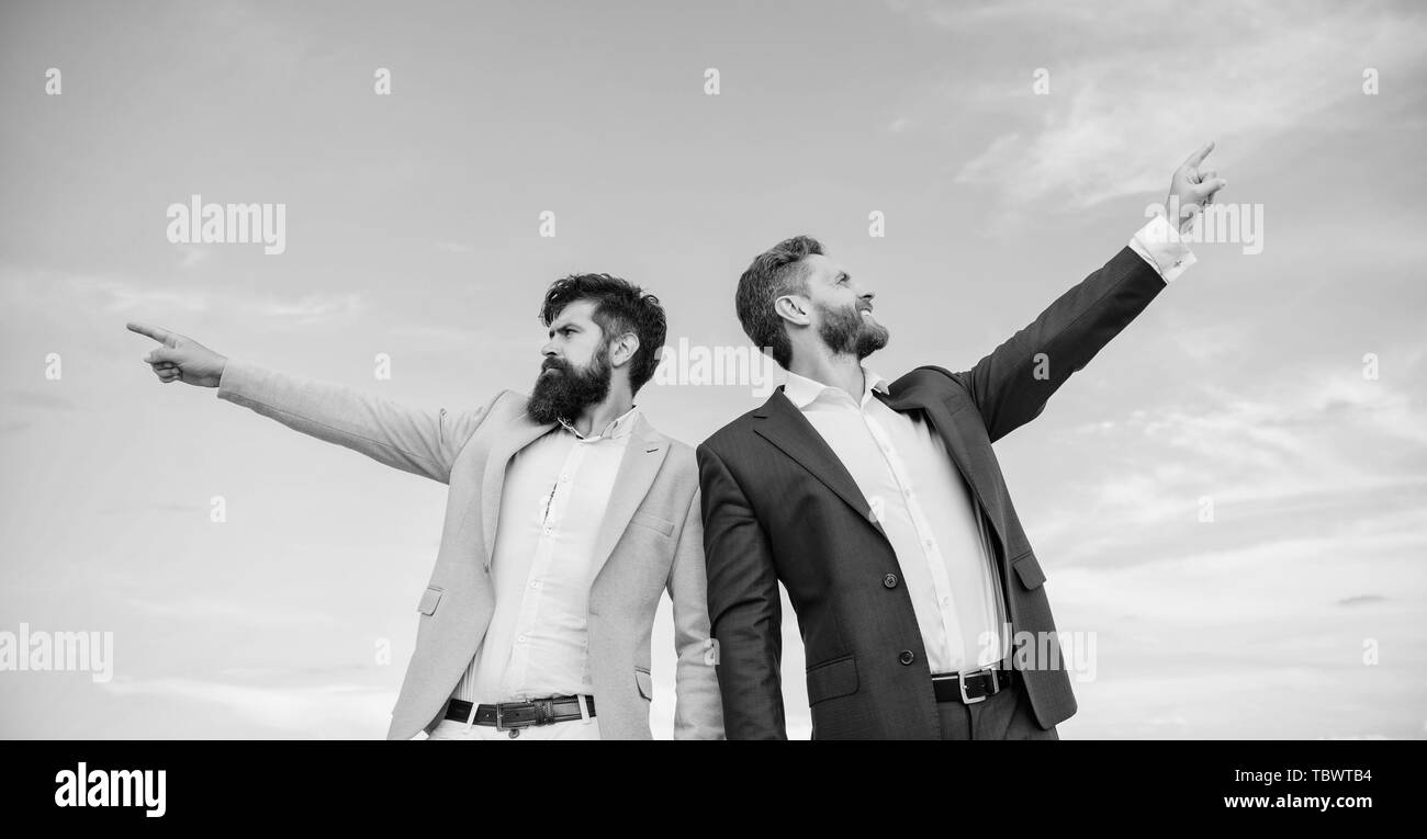 Businessmen bearded faces stand back to back sky background. Men formal ...