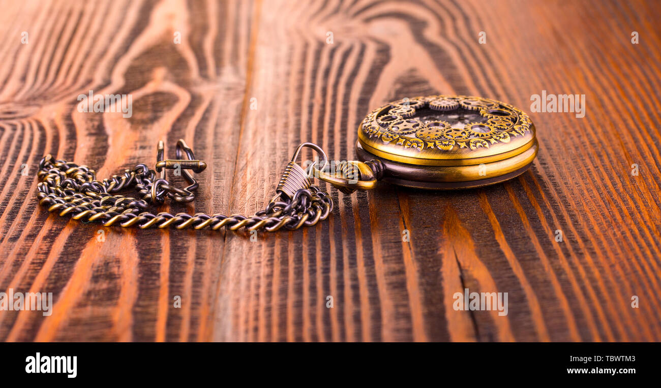 Antique pocket watch lying on wooden background Stock Photo - Alamy