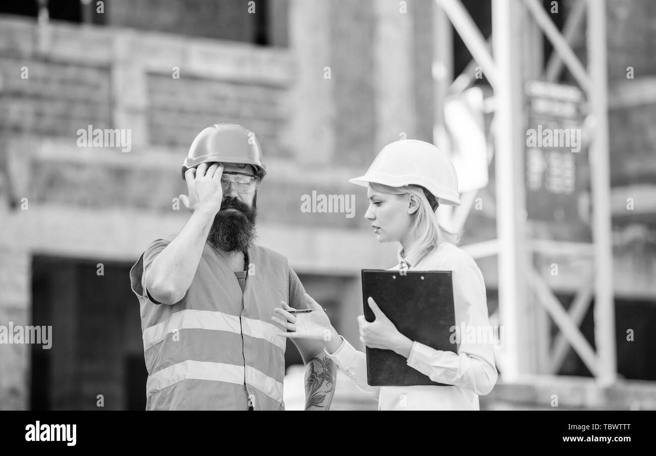 Safety inspector concept. Inspector and bearded brutal builder discuss ...