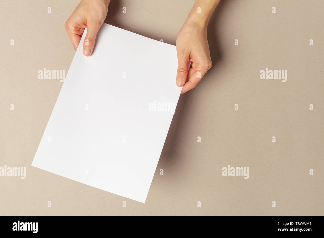 Hand holding papers a4 size Stock Photo - Alamy