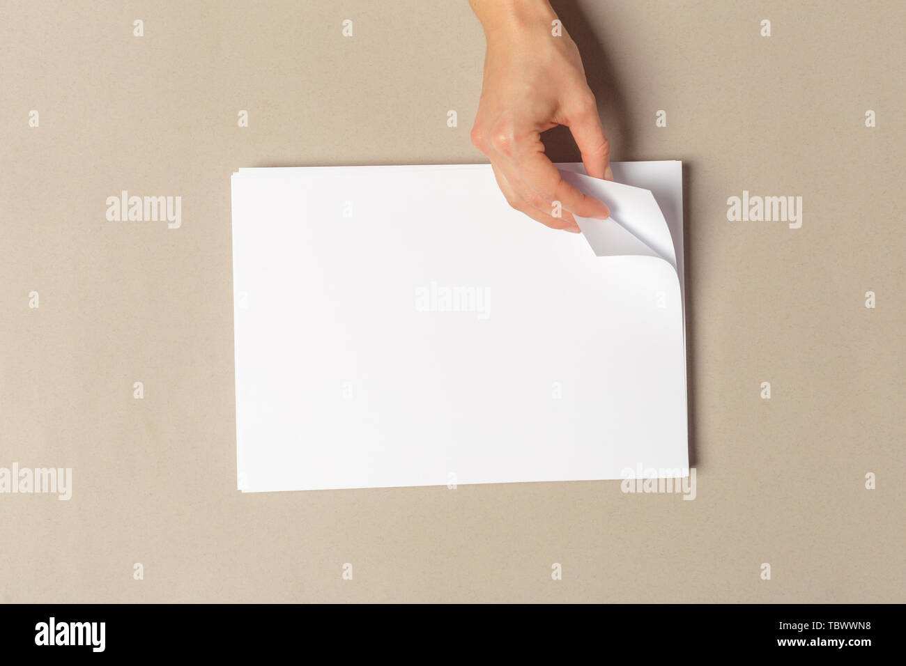 Hand holding papers a4 size Stock Photo - Alamy