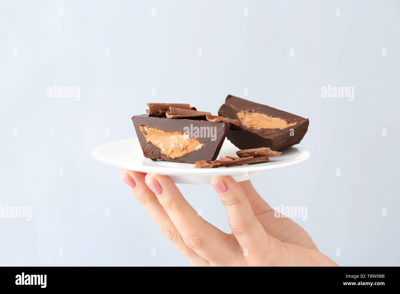 Female hand holding piece chocolate hi-res stock photography and images ...