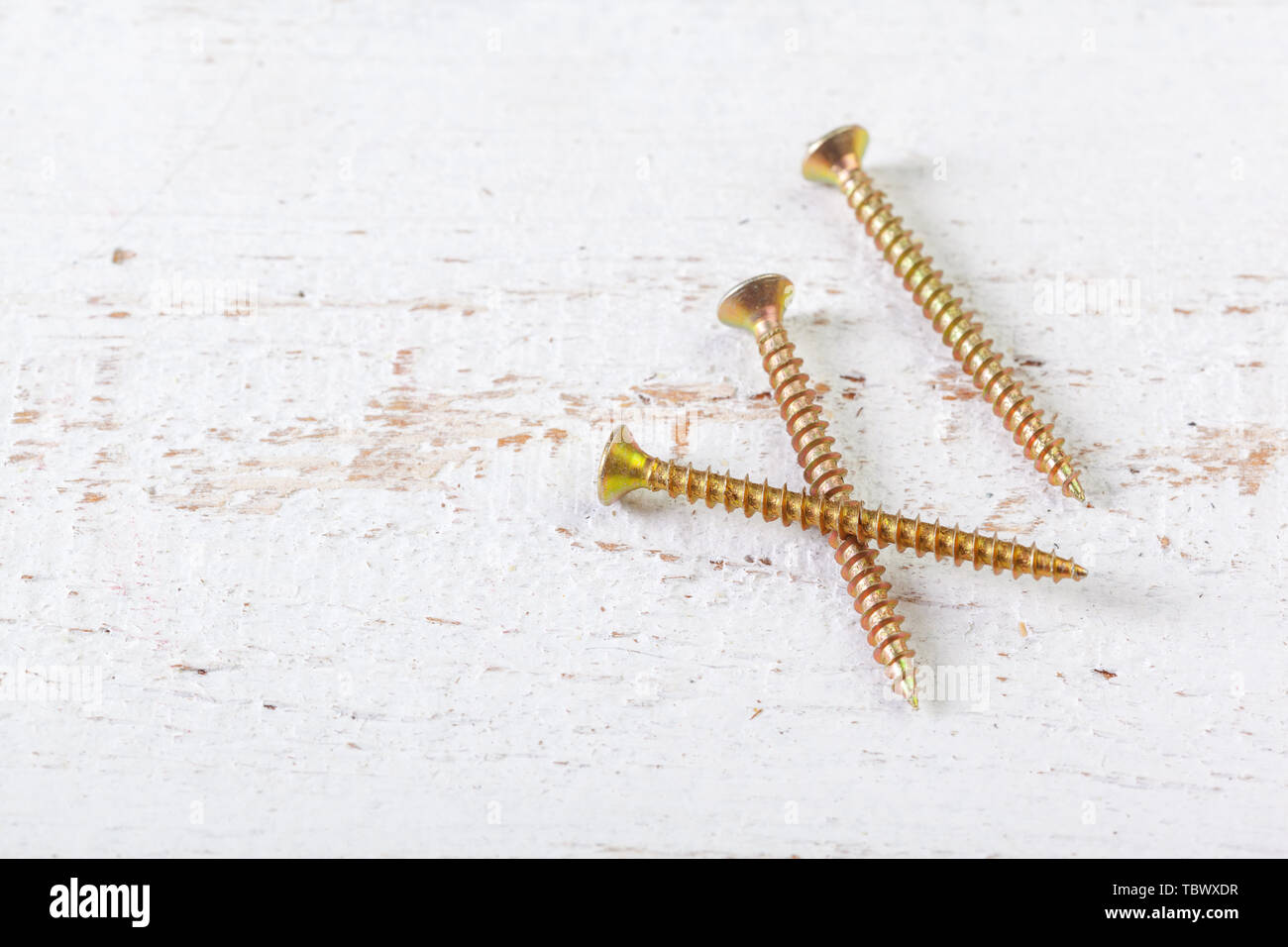 screws on a wooden table Stock Photo - Alamy