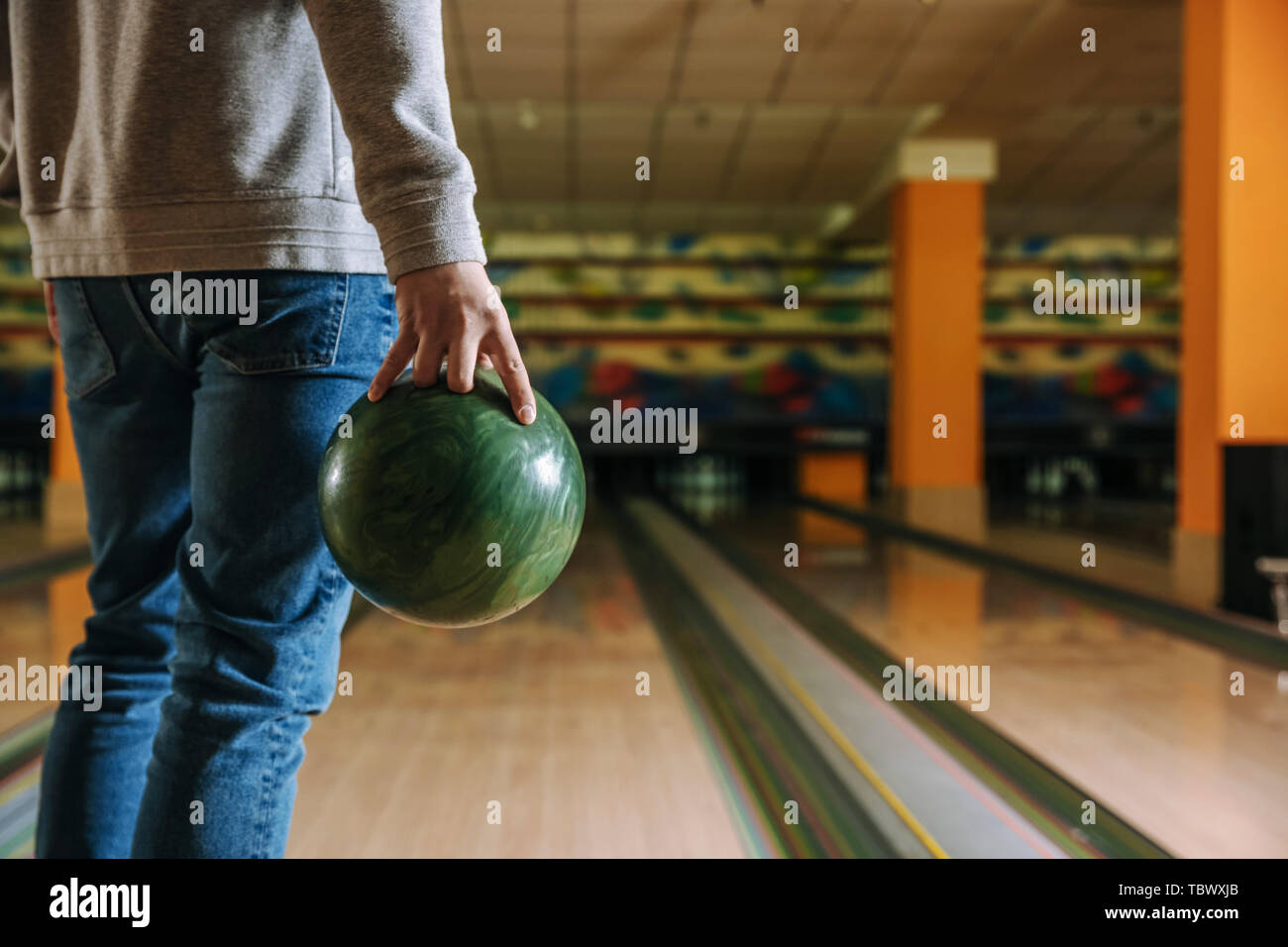 Young man playing bowling in club Stock Photo - Alamy