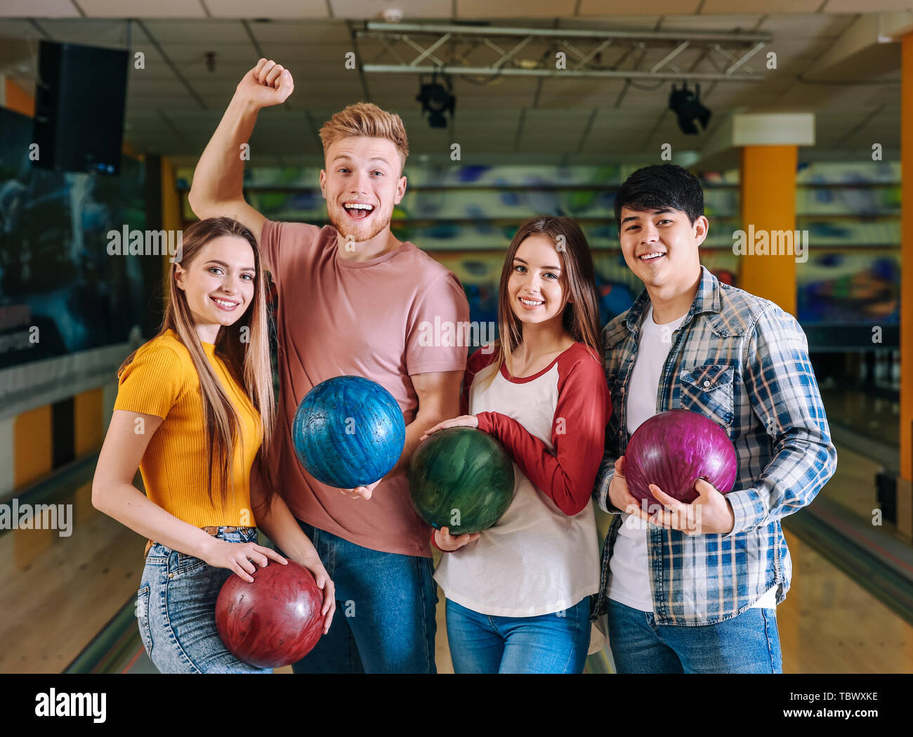 Happy friends in bowling club Stock Photo - Alamy