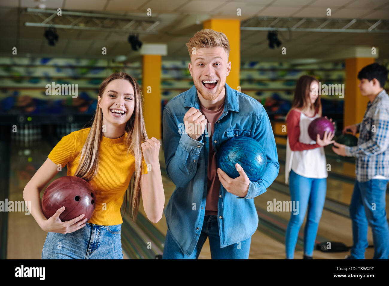 Happy friends in bowling club Stock Photo - Alamy