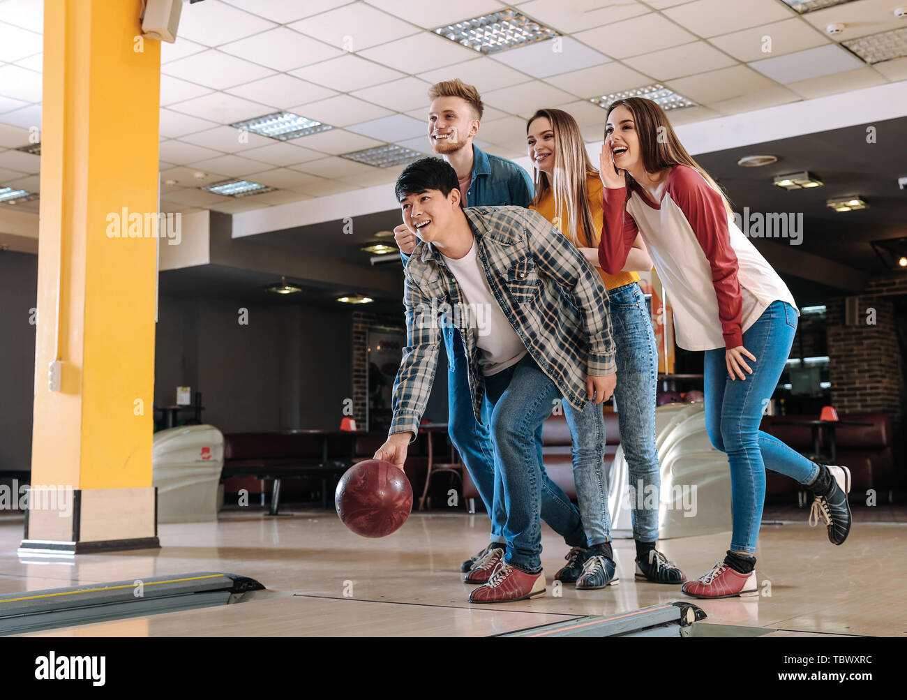 Friends playing bowling in club Stock Photo - Alamy