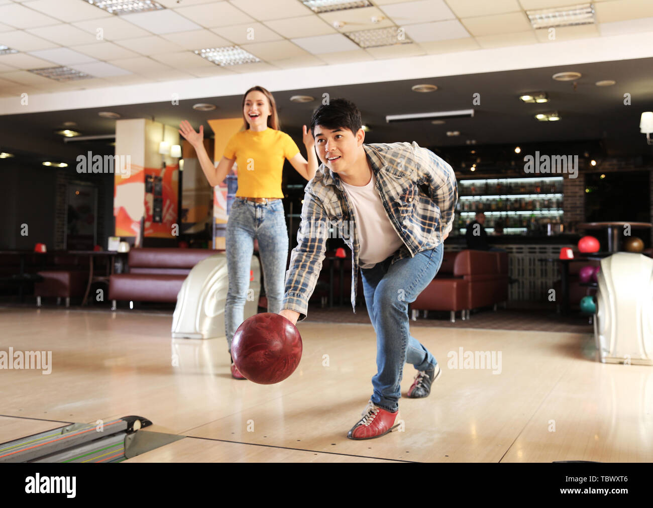 Friends playing bowling in club Stock Photo - Alamy