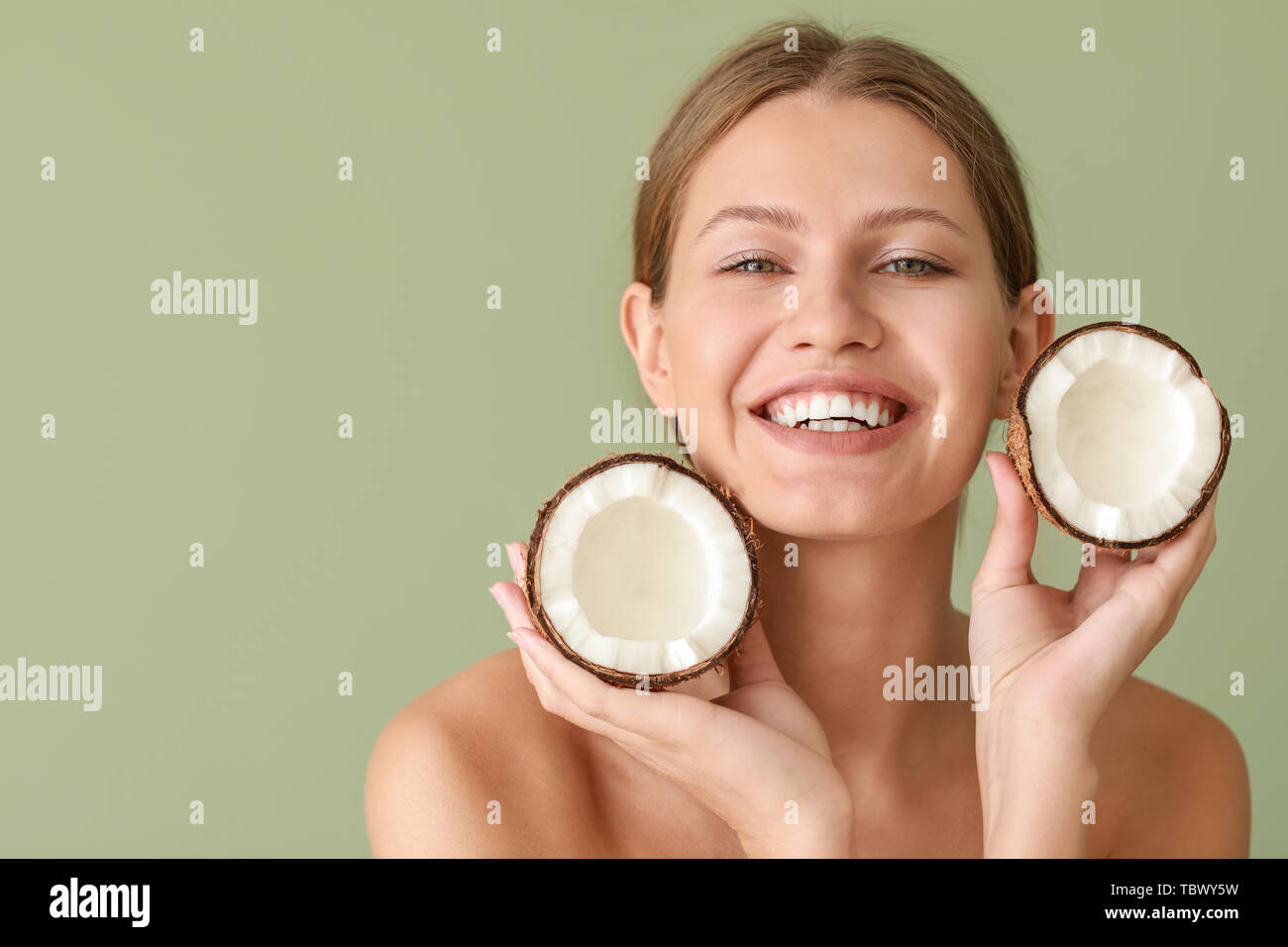 Beautiful young woman with coconut on color background Stock Photo - Alamy