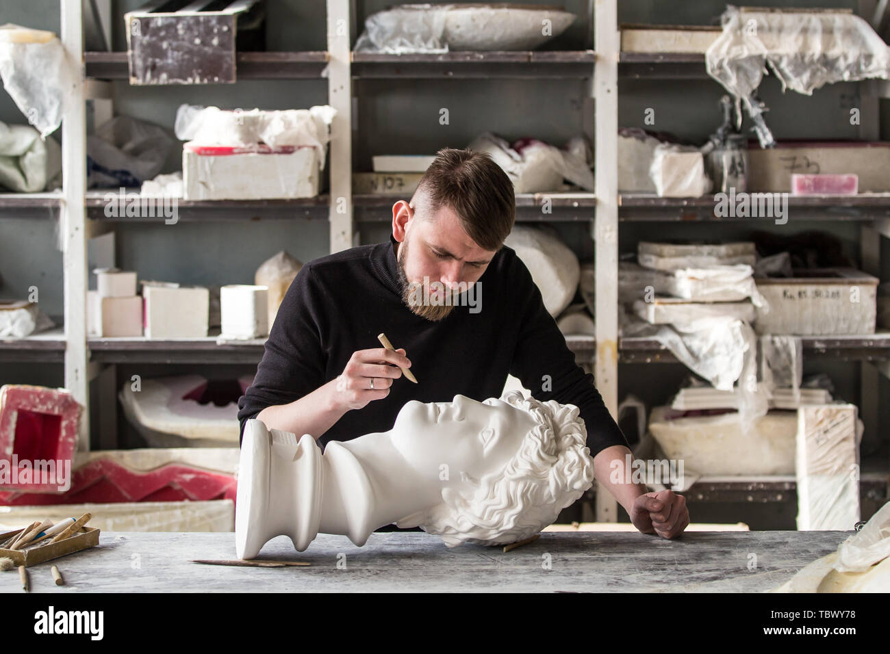 The sculptor conducts restoration work in a plaster workshop ...