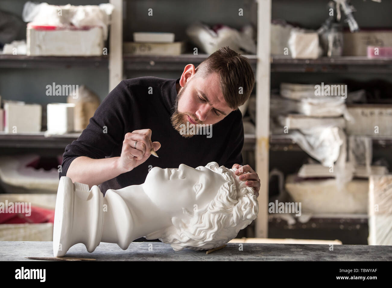 The sculptor conducts restoration work in a plaster workshop ...