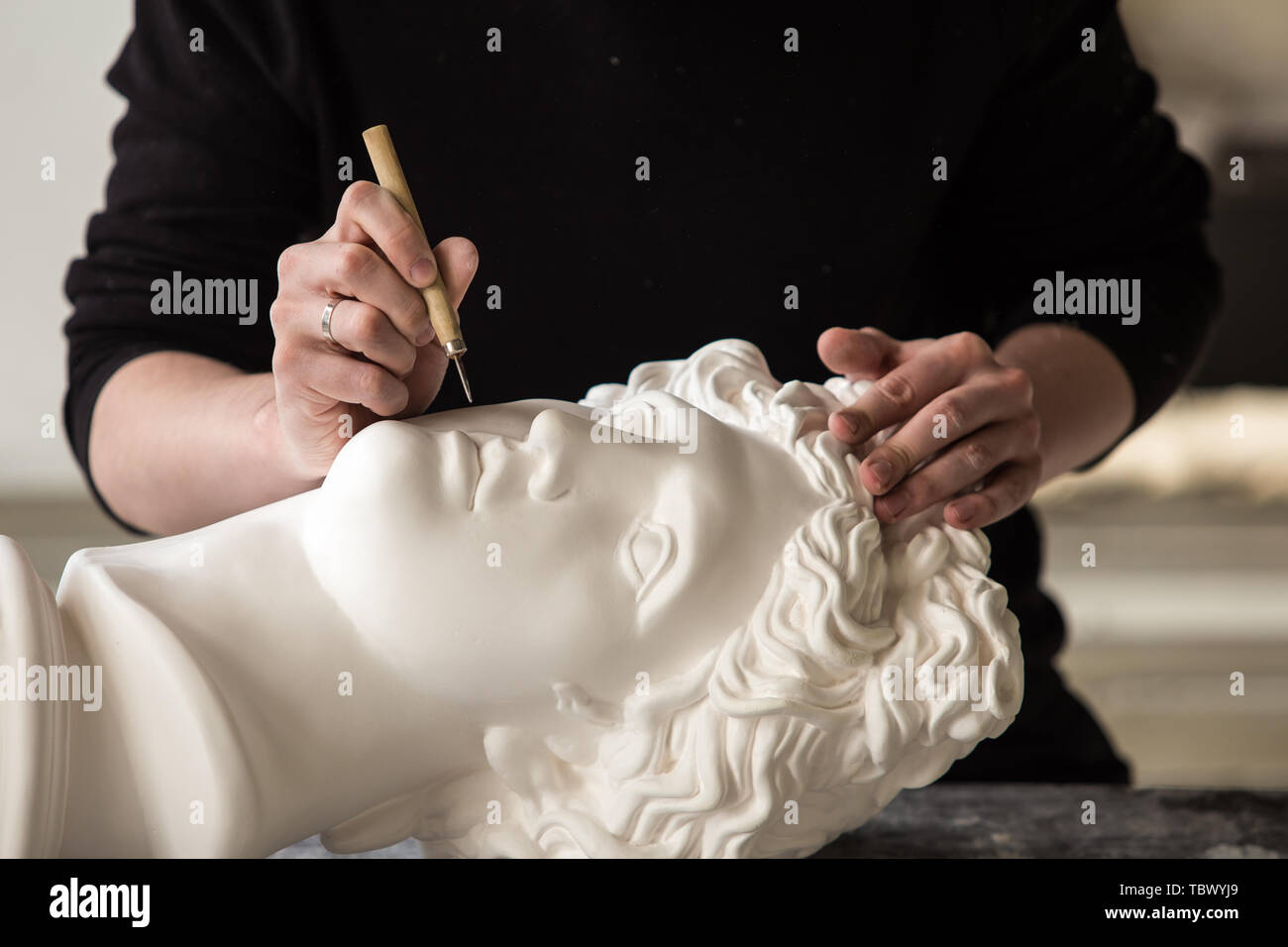 The sculptor conducts restoration work in a plaster workshop ...