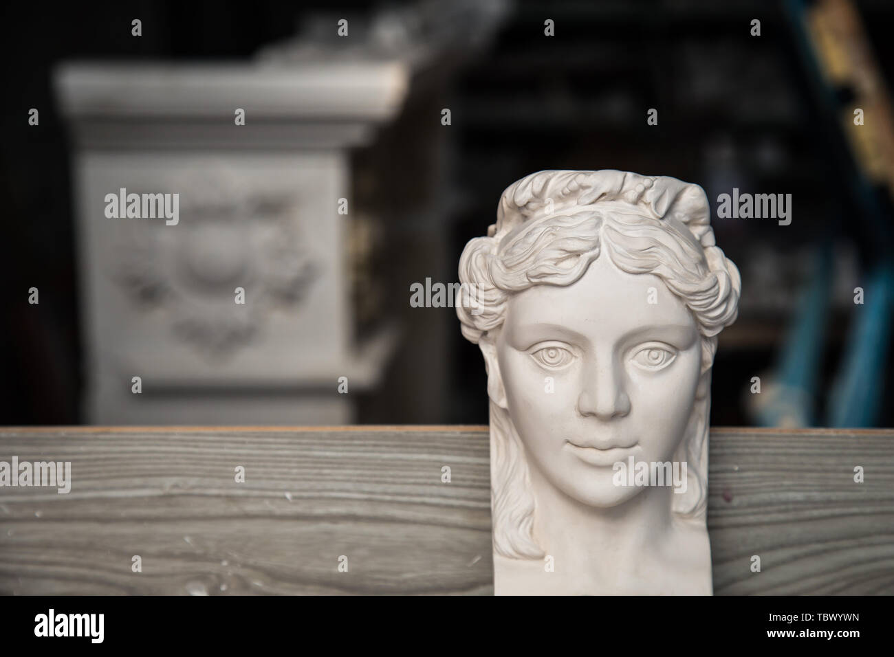 Decorative element made of plaster with a face. The creation of the ...