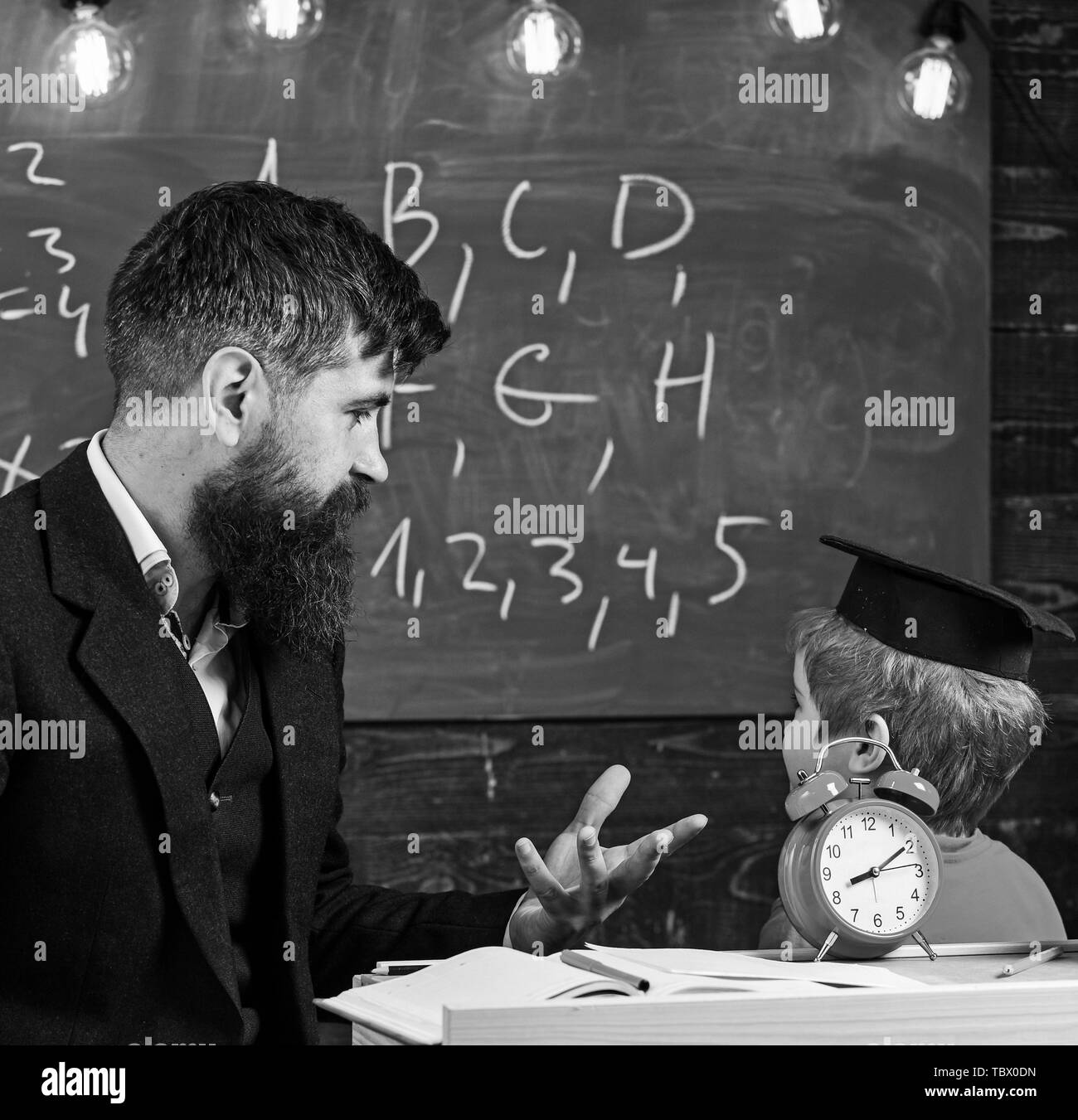 Individual lesson concept. Teacher with beard, father teaches little ...
