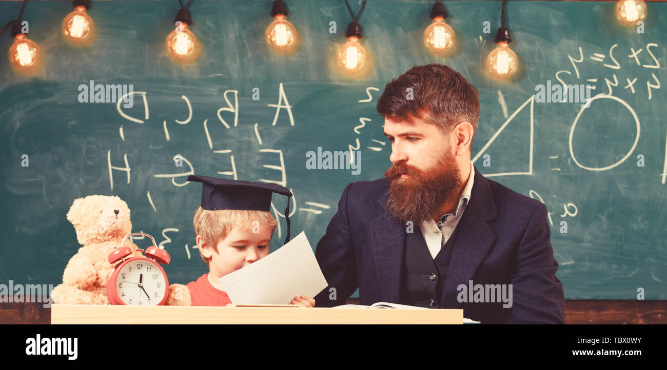 Teacher, father checking homework, helps to boy, son. Individual ...