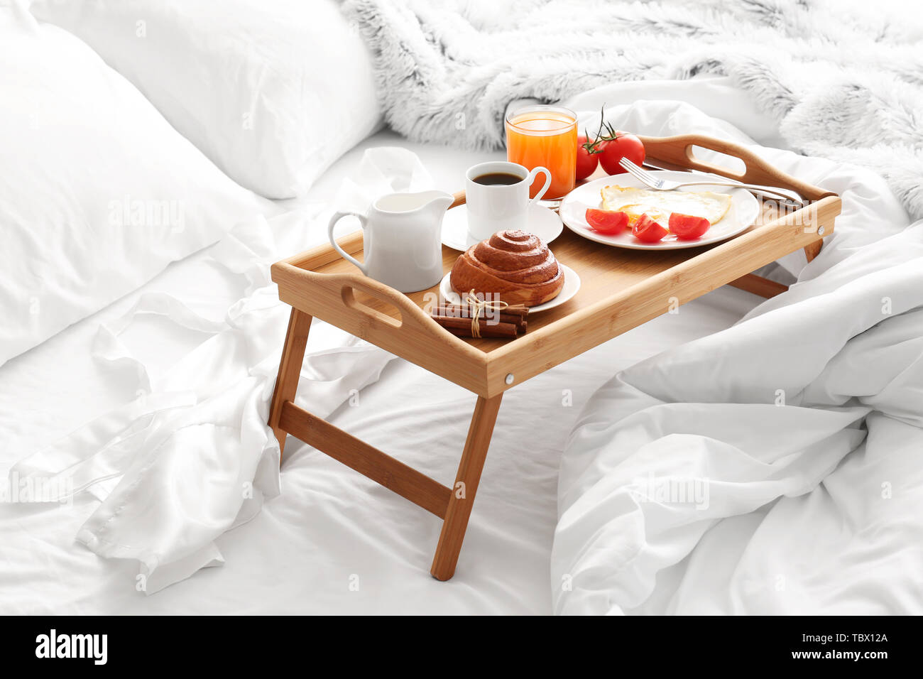 Table with tasty breakfast on bed Stock Photo - Alamy