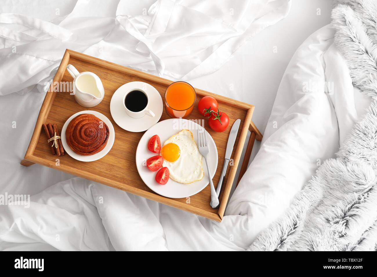 Table with tasty breakfast on bed Stock Photo - Alamy