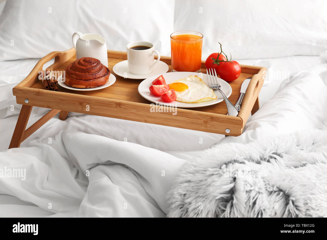 Table with tasty breakfast on bed Stock Photo - Alamy