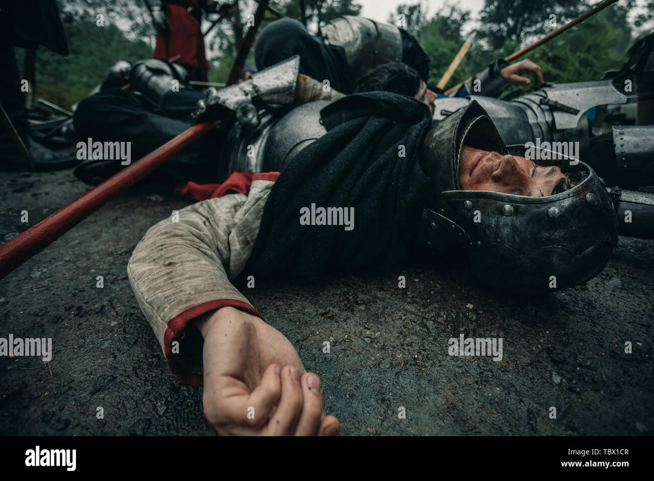 The murdered medieval knights crusaders lie on the ground on the ...