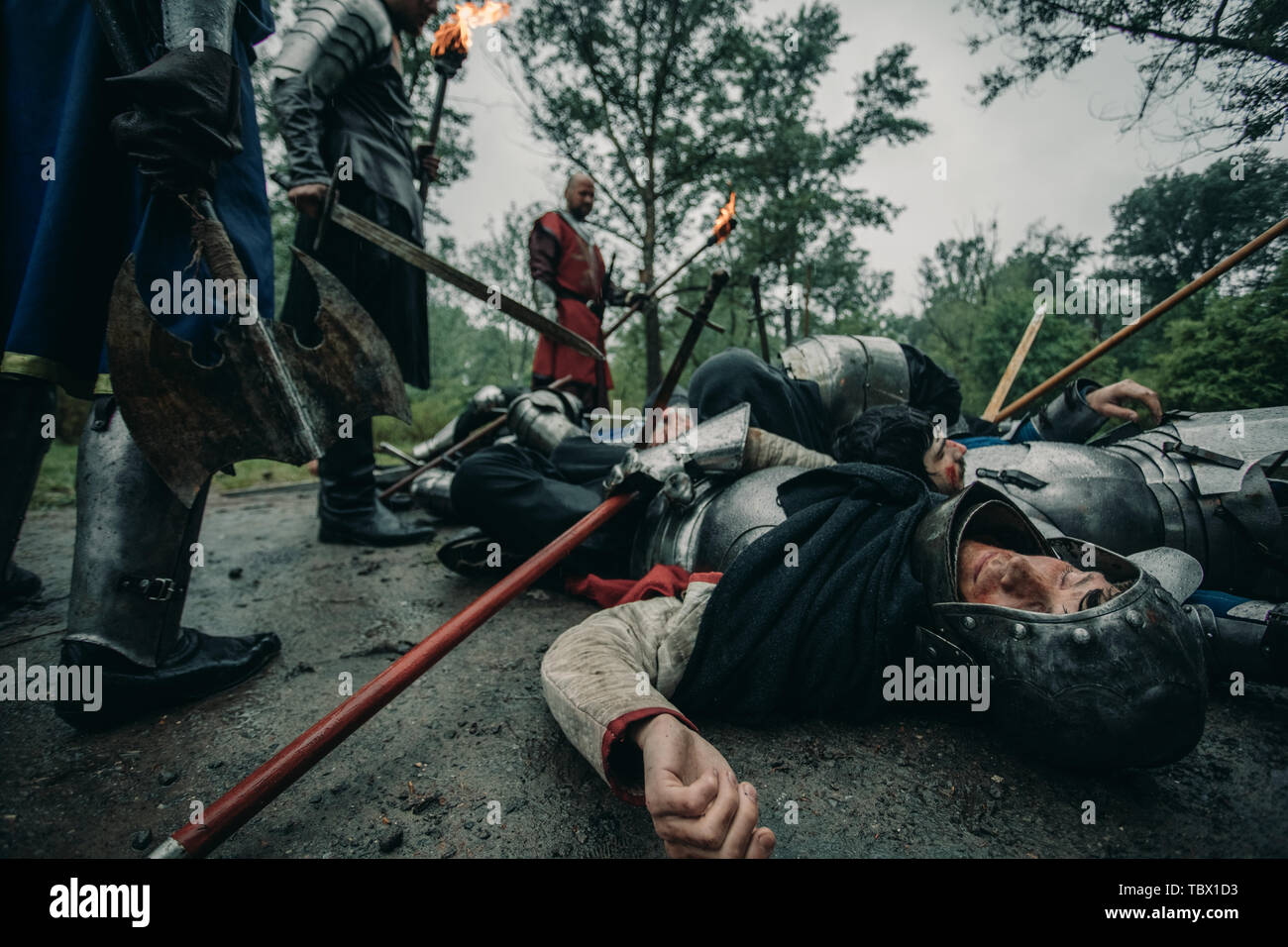 The murdered medieval knights lie on the ground on the battlefield ...