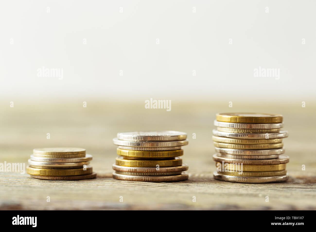 coins stack on wooden table Stock Photo - Alamy