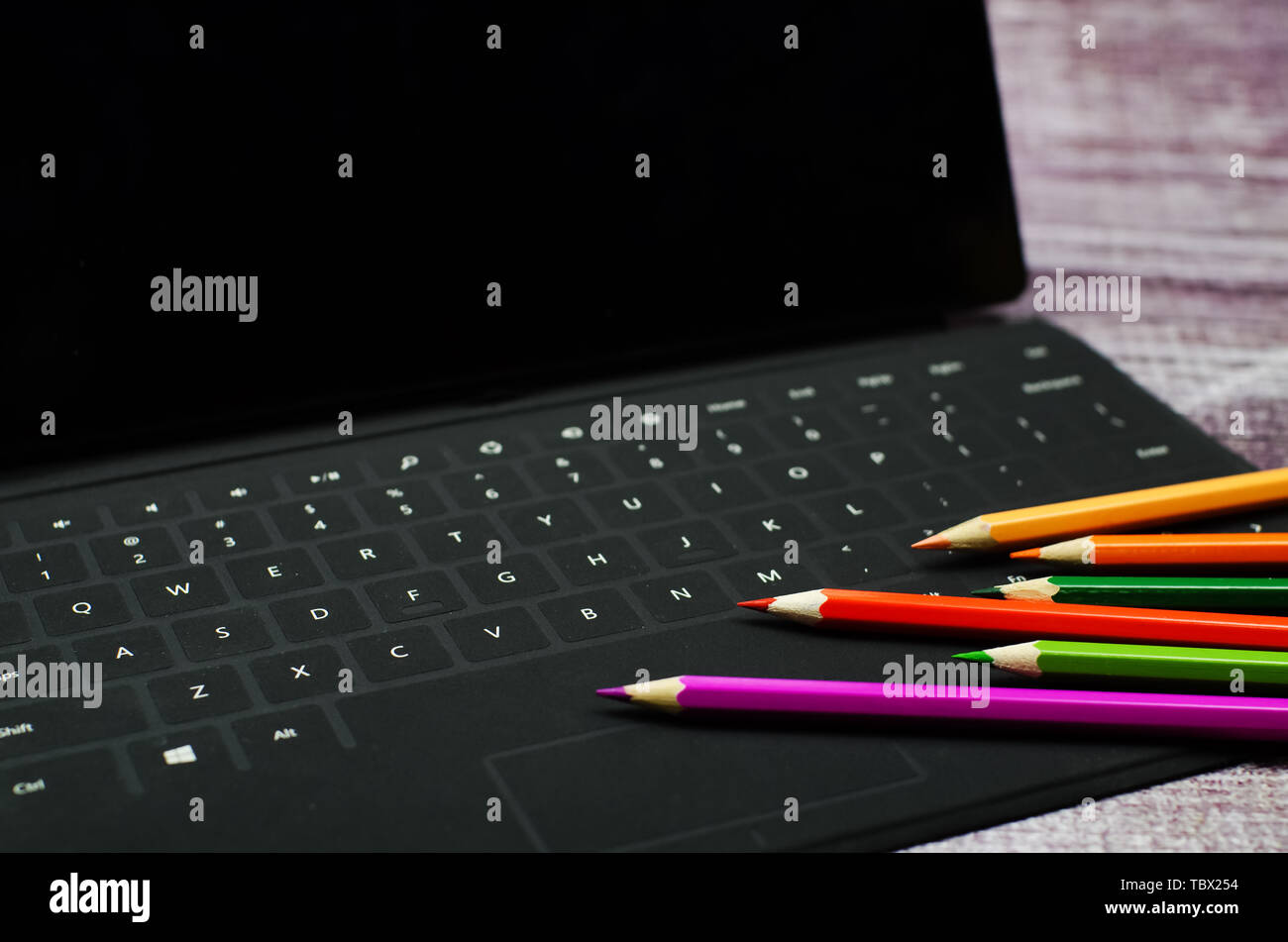Colorful pencils and laptops Stock Photo - Alamy