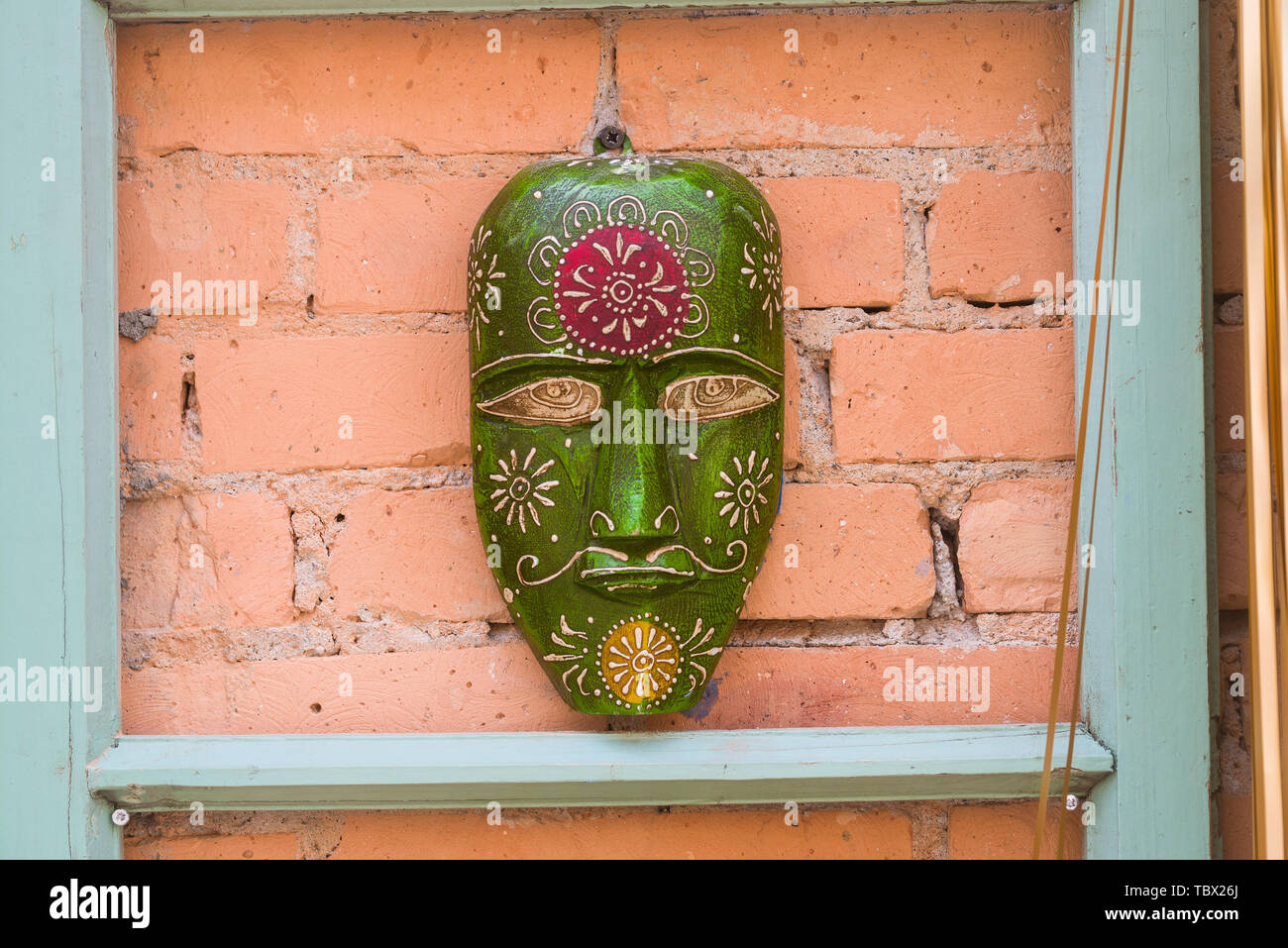 A face hanging from a brick wall Stock Photo - Alamy