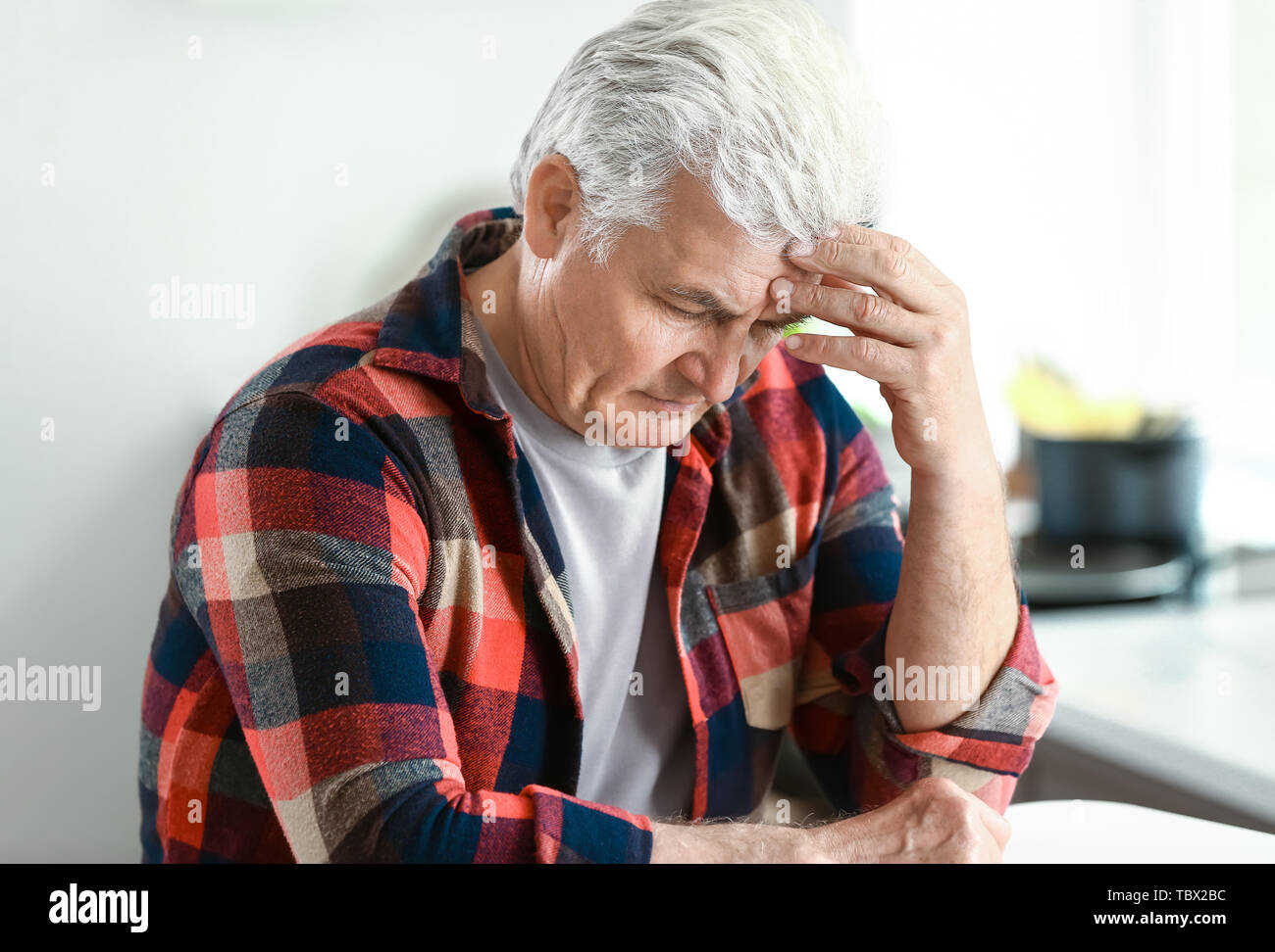 Portrait of sad senior man in kitchen at home Stock Photo - Alamy