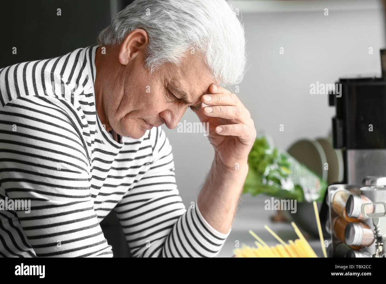 Portrait of sad senior man in kitchen at home Stock Photo - Alamy