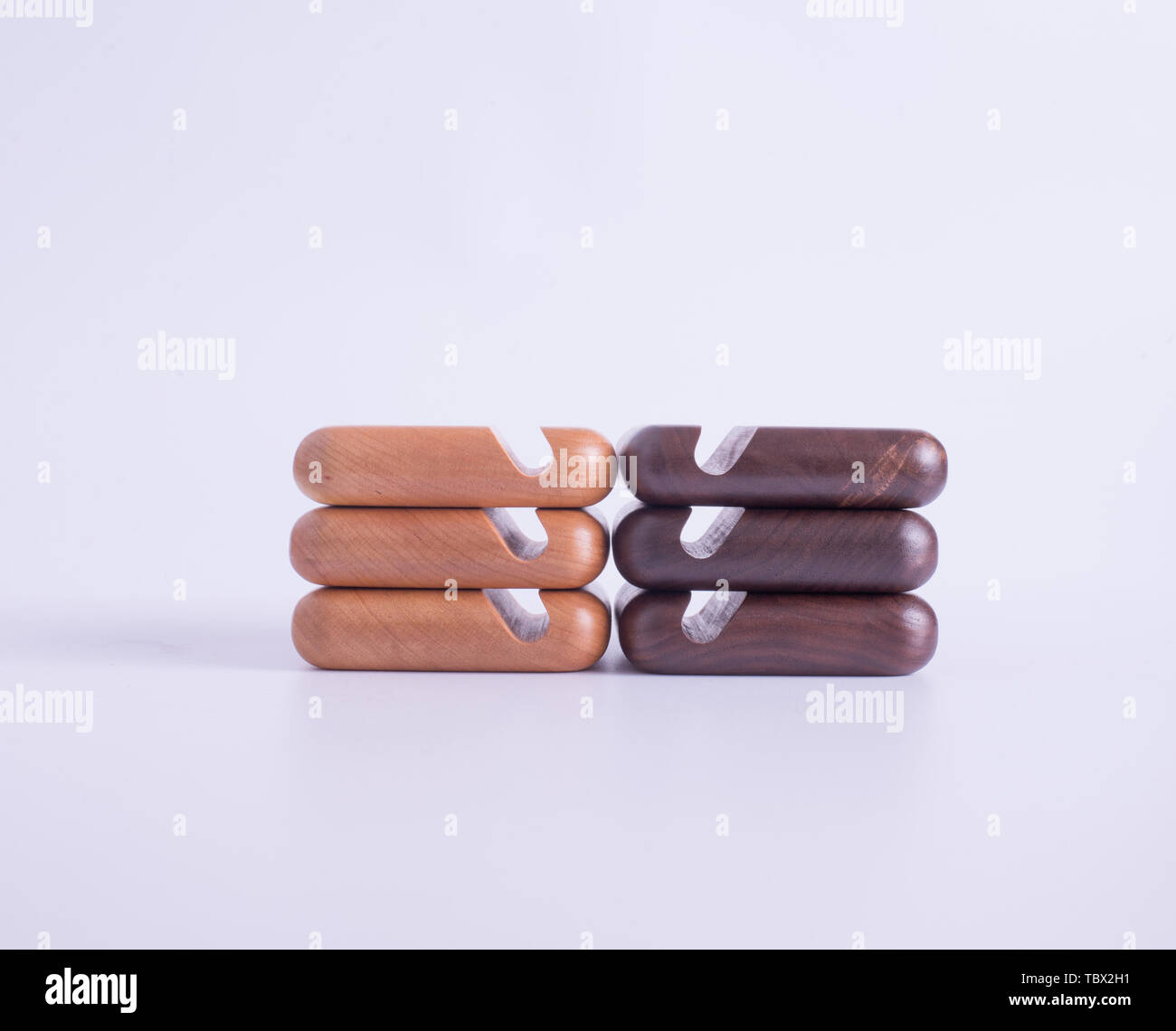 Solid wood mobile phone base on white background Stock Photo - Alamy