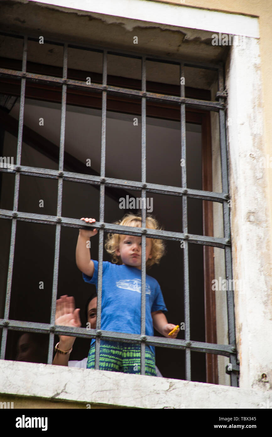 A child looking out of a window by the canal Stock Photo - Alamy