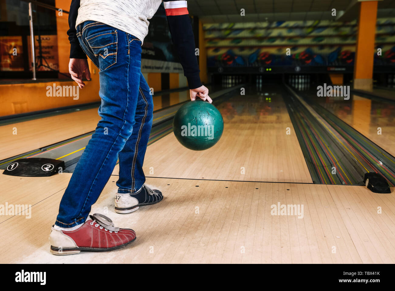 Little boy playing bowling in club Stock Photo - Alamy
