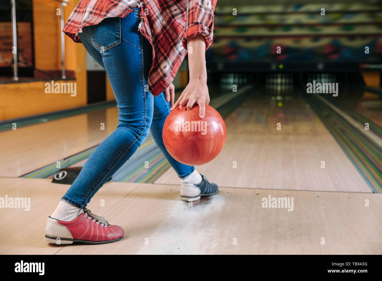Woman playing bowling in club Stock Photo - Alamy