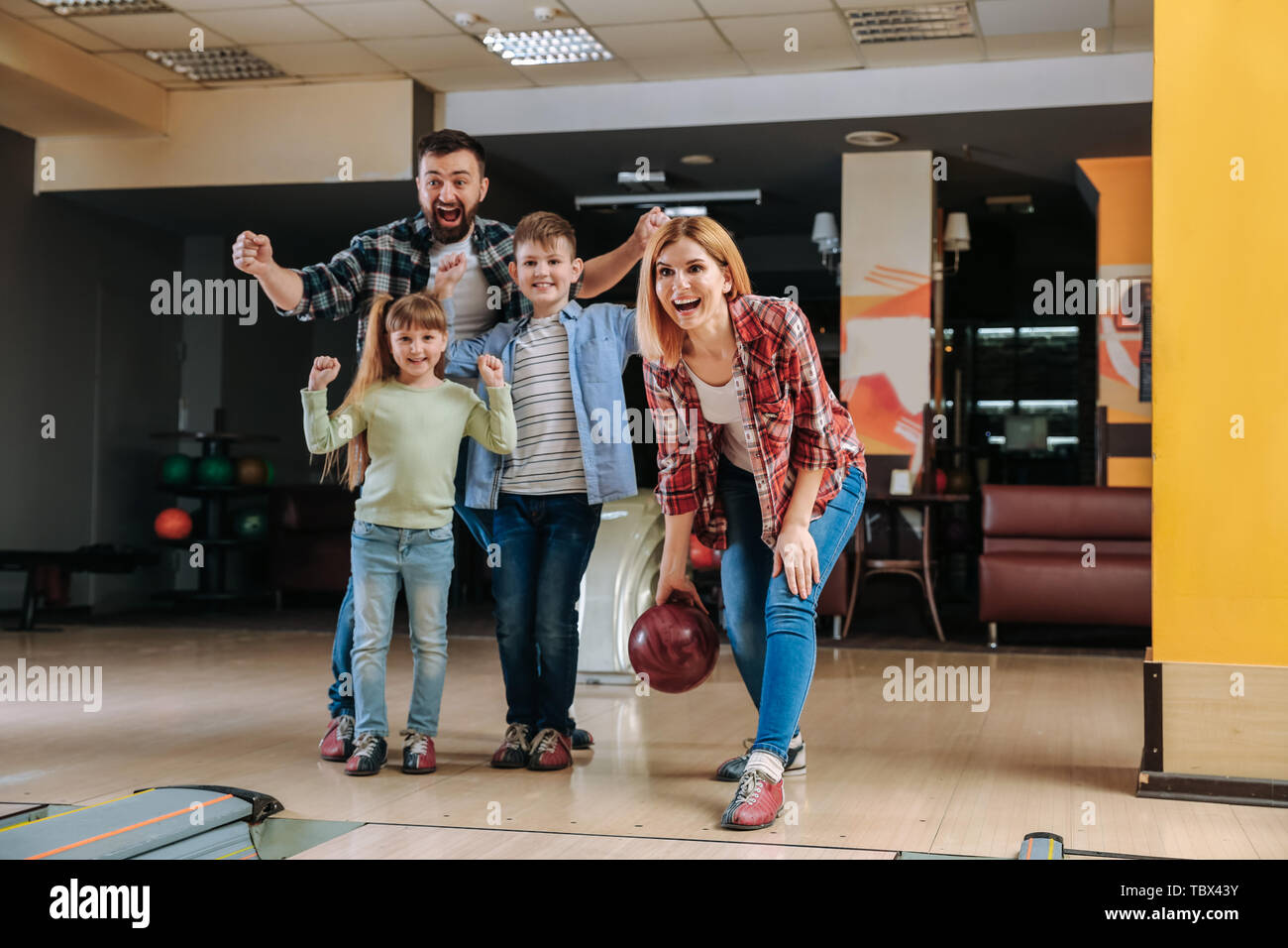 Family playing bowling in club Stock Photo - Alamy