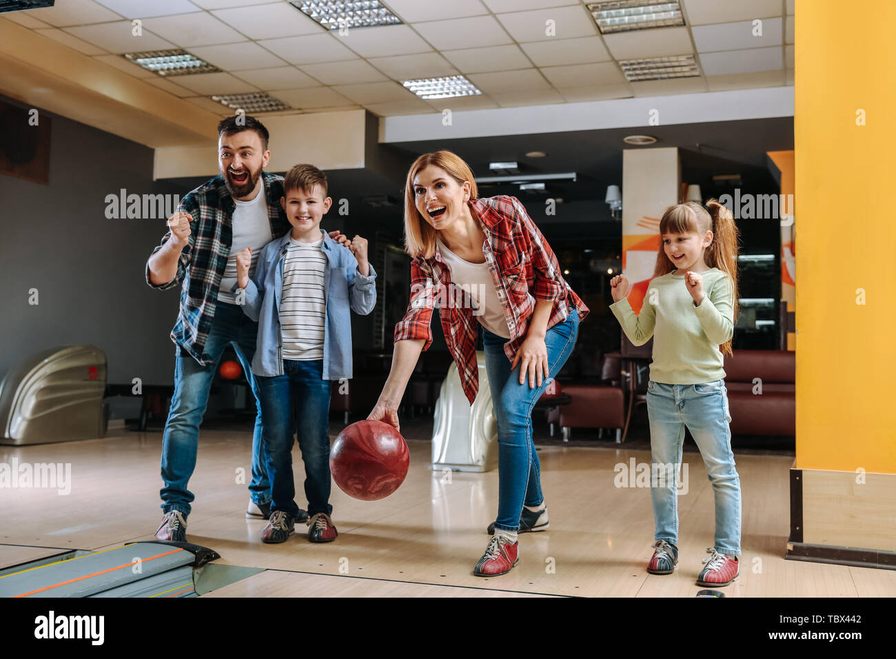 Family playing bowling in club Stock Photo - Alamy