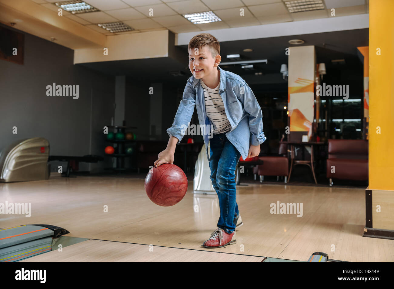 Little boy playing bowling in club Stock Photo - Alamy