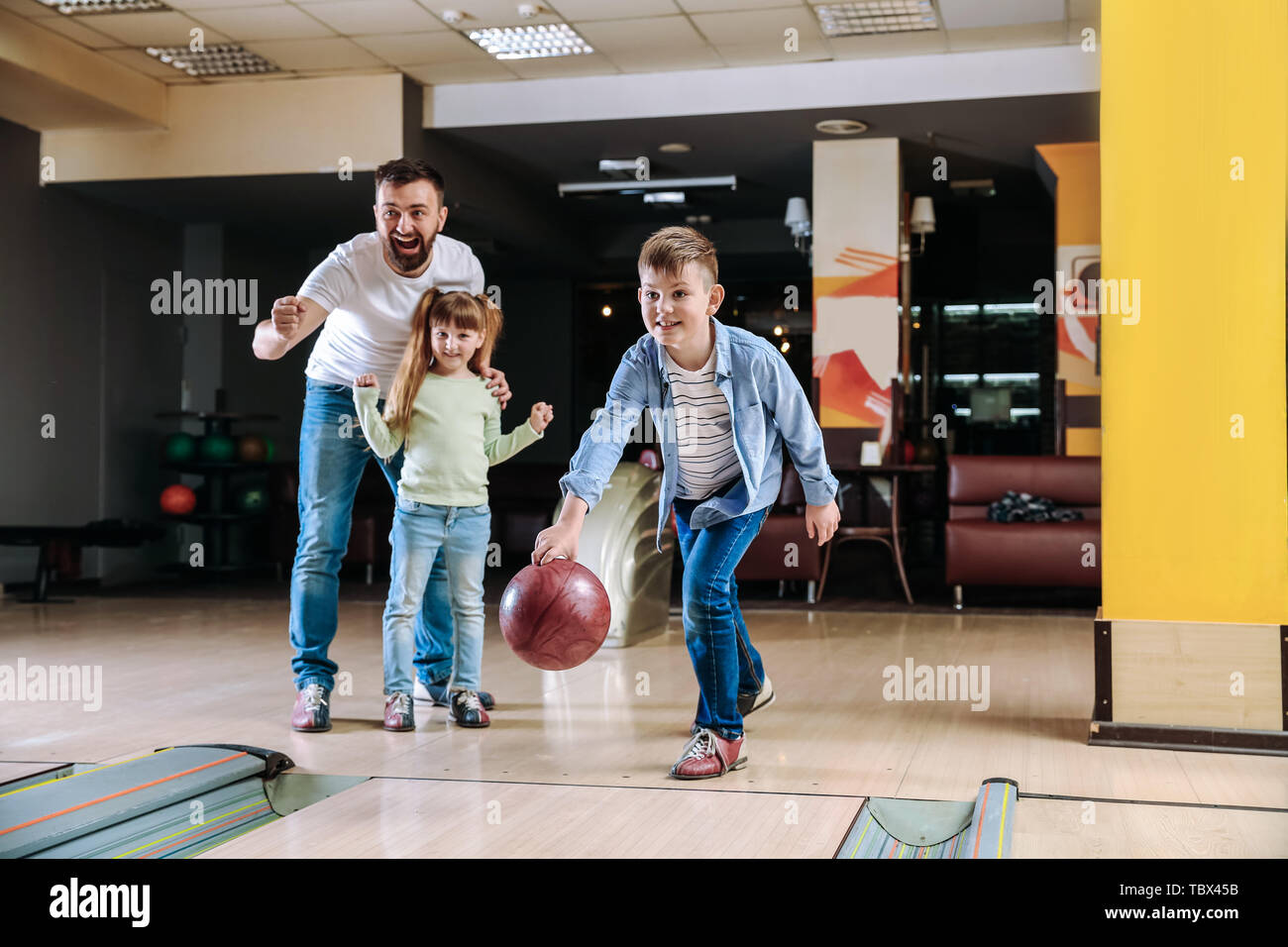 Family playing bowling in club Stock Photo - Alamy