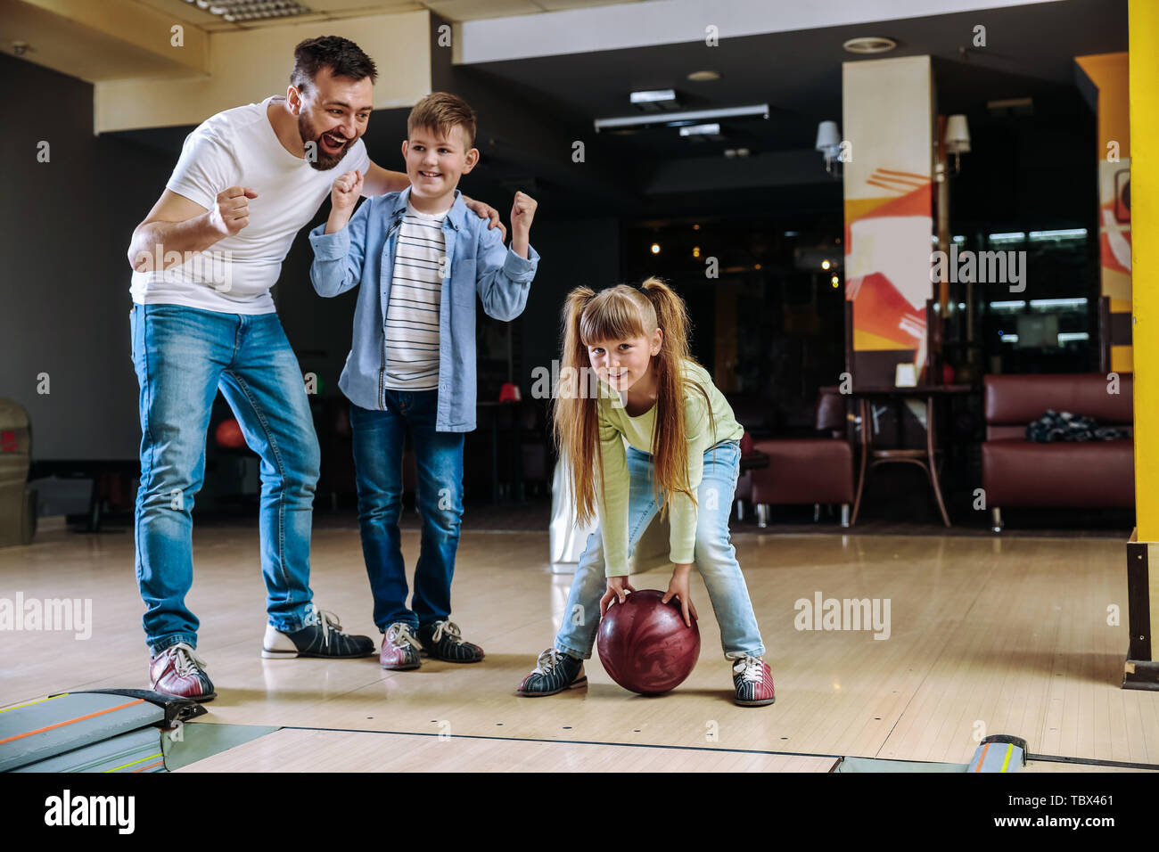 Family playing bowling in club Stock Photo - Alamy